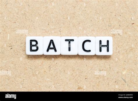 white tile alphabet letter with word batch on wood background stock