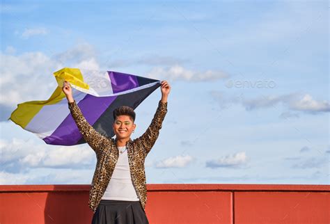 Gender Non Binary Asian Person Smiling Holding Gender Non Binary Flag