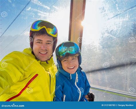 Smiling Skiers Dad And His Teen Son On Sunny Cable Car Lift Ride Stock Image Image Of