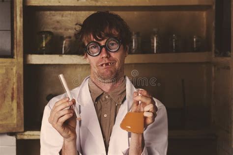 Creepy Scientist Doing Weird Experiments In His Laboratory Stock Image