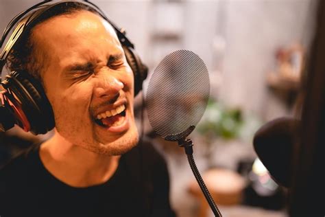Premium Photo Singer Wearing Earphones Working To Record And