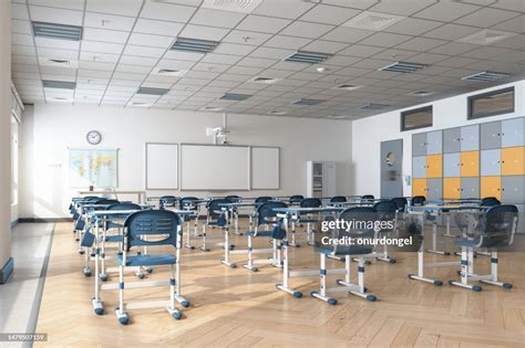 Empty Modern Classroom Interior With Desks Blue Chairs Cabinets And