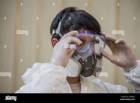 Man In Personal Protective Equipment Ppe Suit Wearing Clear Glasses And Protective Gas Mask