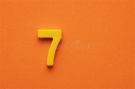 Number Seven Yellow Plastic Plastic Digit On Orange Foamy Background Stock Image Image Of