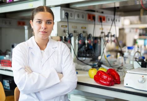 Young Female Scientist Standing With Crossed Hands In Laboratory Stock