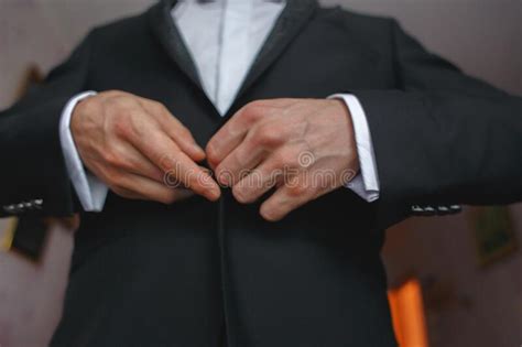 Groom In Black Tuxedo And Bowtie Correct His Buttons On White Shirt Wedding Stock Photo Image