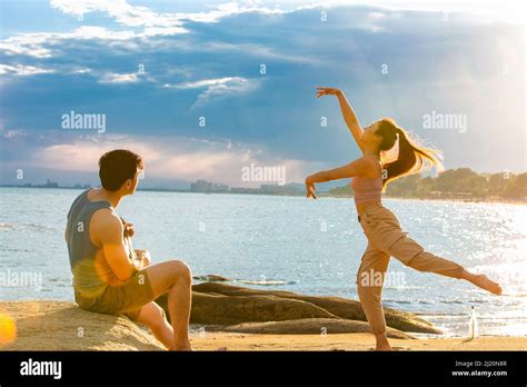 Newlyweds Enjoying Their Honeymoon At The Beach Under The Summer Sun