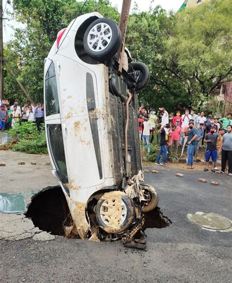 Delhi Emulates Mumbai Traffic Cops Car Gets Swallowed By Sinkhole
