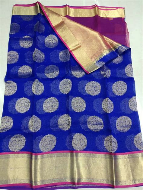 A Blue And Gold Banaram Saree With Polka Dots On The Border