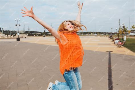 Premium Photo A Fullsize Portrait Of A Cheerful Positive Girl Jumping