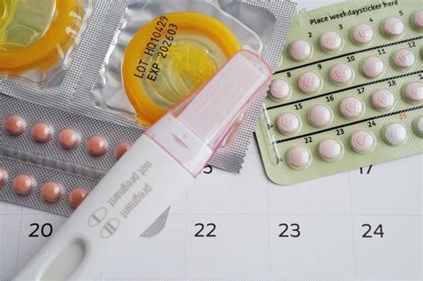 Premium Photo Pregnancy Test With Birth Control Pills And Condom For