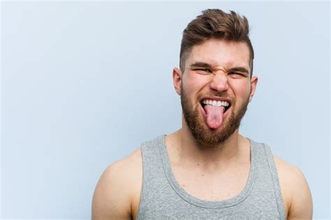 Premium Photo Young Handsome Fitness Man Funny And Friendly Sticking