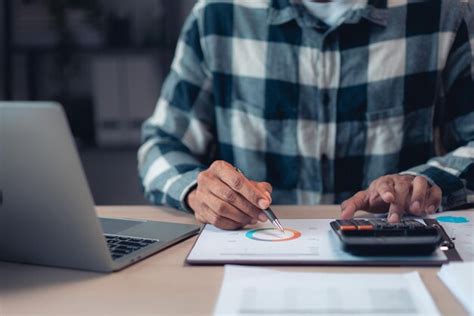 Premium Photo Businessman Use Calculator To Calculation And Checking