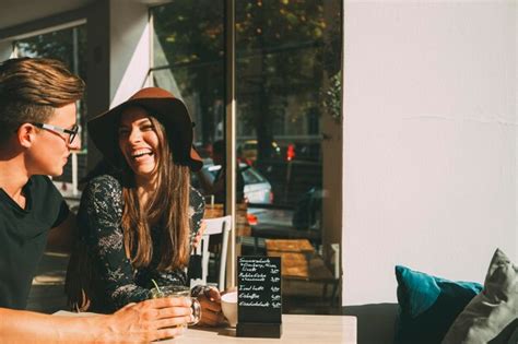 Premium Photo Couple Sitting In A Coffee Shop Having Fun