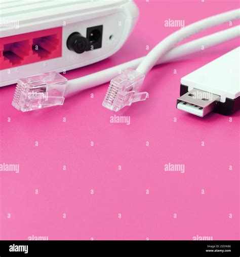 Internet Router Portable Usb Wi Fi Adapter And Internet Cable Plugs Lie On A Bright Pink