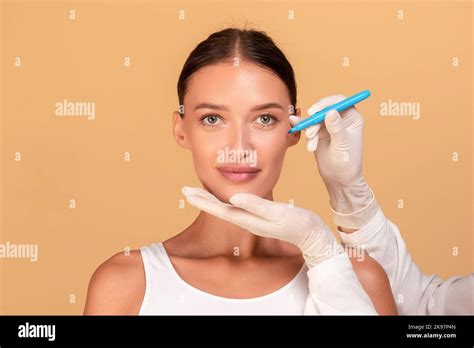 Lady Before Plastic Surgery Operation Beautician Touching And Drawing