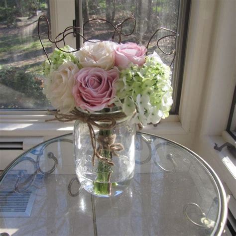 A Vase Filled With Flowers Sitting On Top Of A Glass Table Next To A Window