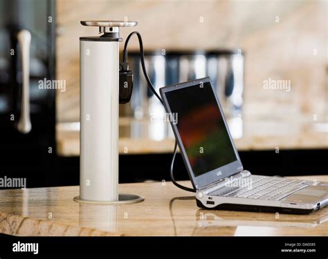 Laptop Plugged Into Retractable Power Point Set In Kitchen Worktop Stock Photo Alamy