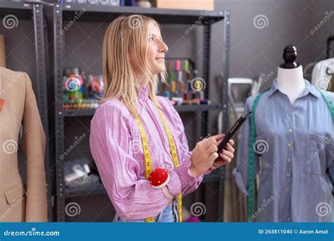 Young Blonde Woman Tailor Smiling Confident Using Touchpad At Tailor