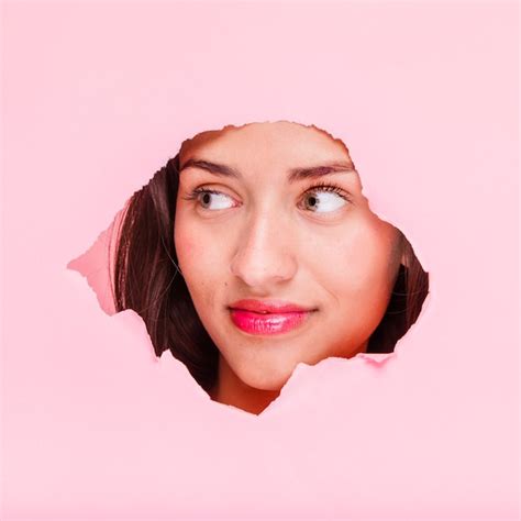 Free Photo Brunette Girl Posing Through A Paper Hole