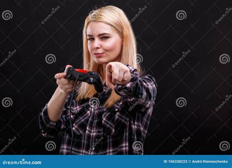 A Young Girl Holds A Joystick And Shows Her Finger In Front Of Her