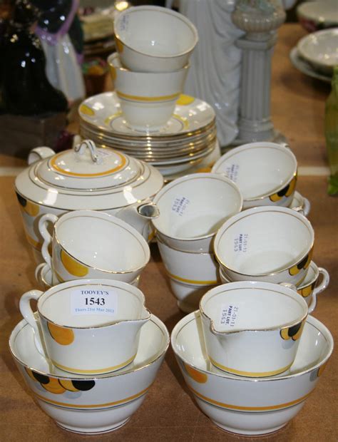 An Art Deco Palissy Porcelain Part Tea Service Comprising Two Square Cake Plates A Teapot And Cove