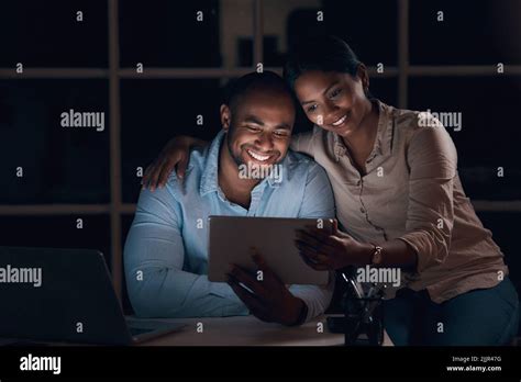 Working Hard So That She Doesnt Have To A Young Couple Using A Digital