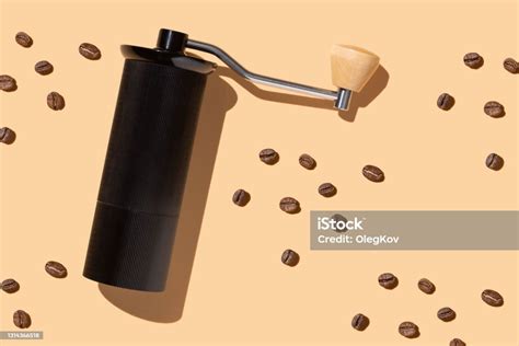 베이지 색 배경에 커피 콩 연삭 공정 개념 콩 수동 커피 분쇄기 하드 트렌드 라이트 0명에 대한 스톡 사진 및 기타 이미지