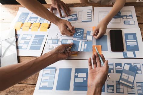 Close Up Ux Developer And Ui Designer Brainstorming About Mobile App