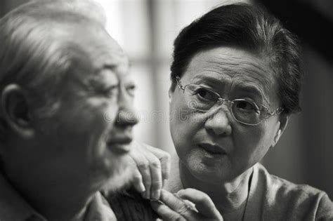 Senior Asian Wife Looking At Husband With Concern Stock Image Image