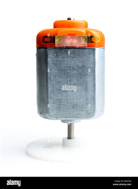 Direct Current Electric Motor With White Gear Attached To It Shaft On A White Background Macro