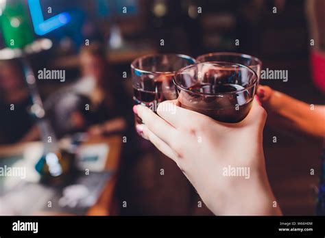 Male Hands Cheer With Glasses Of Shot Or Liqueur Friends Drink Shot Or
