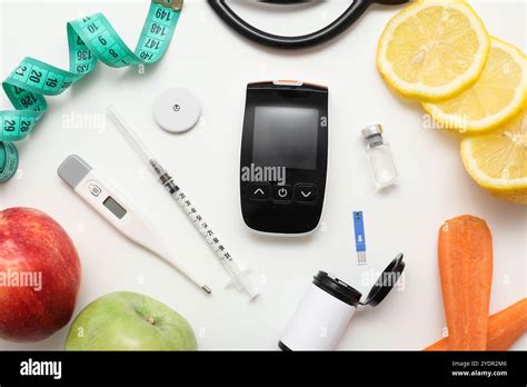 Glucometer With Glucose Sensor Insulin And Fruits On White Background