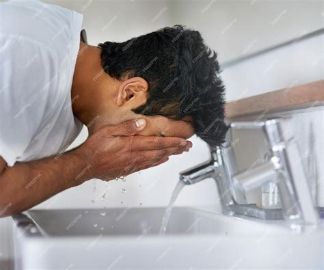 Premium Photo Water Wash And Man In Bathroom For Hygiene Grooming And Cleaning Face At Home