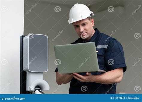 Qualified Technician Working With Laptop For Home Ev Station