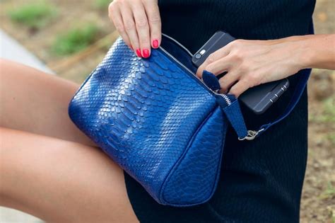 Premium Photo Girl Holding A Bag Made Of Exotic Python Skin