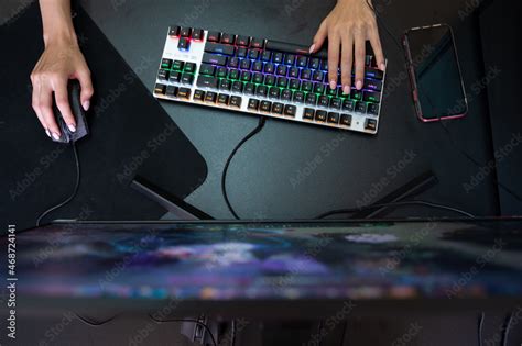 Focus On Hands Keyboards And Mouse Back View Of Babe Gamer Playing Video Game Wearing