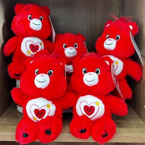 Adorable Care Bears Sitting On A Wooden Shelf