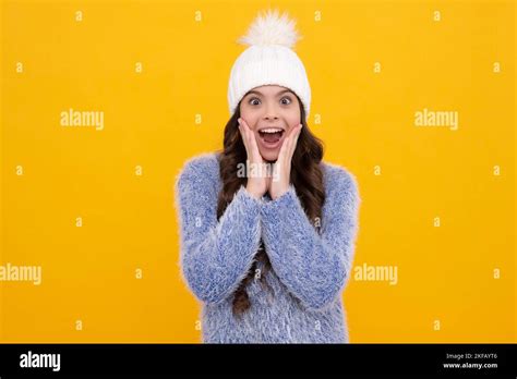 Modern Teen Girl Wearing Sweater And Knitted Hat On Isolated Yellow