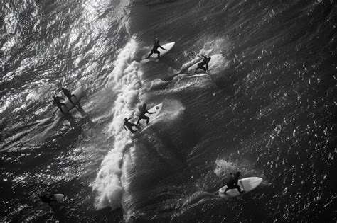 Premium Photo A Group Of People Riding Surfboards On Top Of A Wave