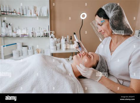 Close Up Of An Esthetician Making Facial Cleansing Procedure In A