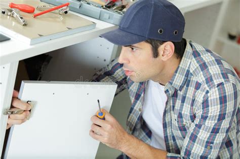Man Fixing Cupboard Stock Photo Image Of Homeimprovement 311726370