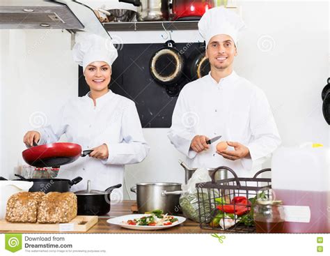 Two Chefs Cooking Food Pretty Men Women Restaurant S Kitchen 74737124