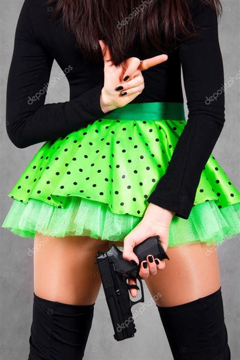 Back View Portrait Of A Woman Holding A Gun And Showing A Fuck Stock Photo Artzzz 64406397