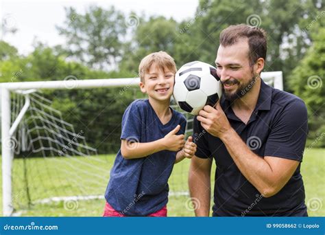 Father With Son Playing Football On Football Pitch Stock Photo Image