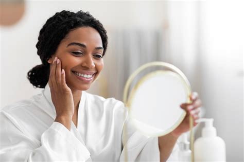 Premium Photo Attractive Black Woman Looking At Mirror And Touching