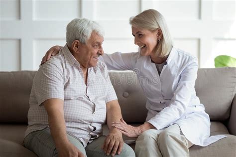 Friendly Mature Grandfather And Young Adult Grandson Give Fist Bump