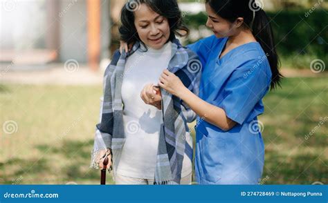 Asian Careful Caregiver Or Nurse Hold Patient Hand And Encourage