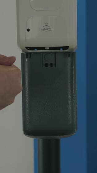 close up of washing hands with an automatic alcohol sanitizer dispenser
