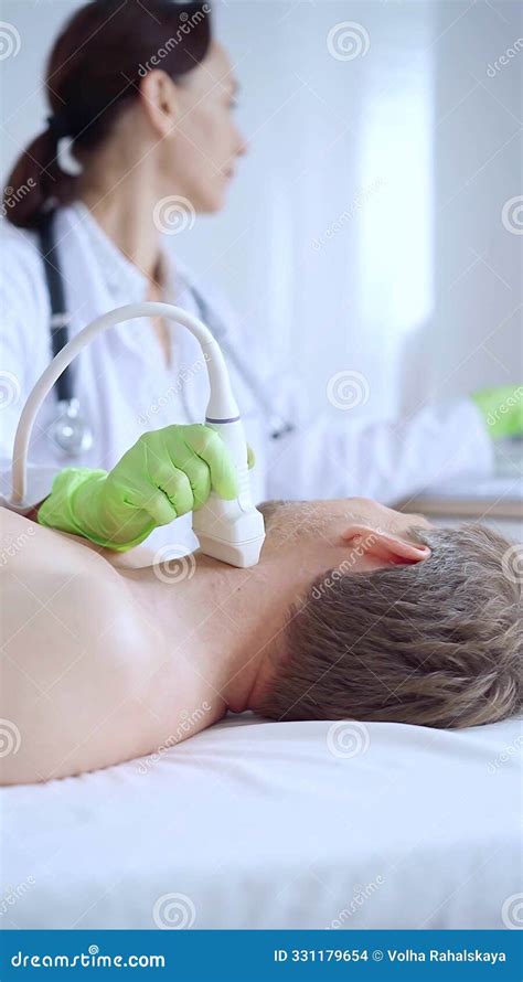 Doctor Woman With Green Medical Gloves Performing Neck Ultrasound Exam